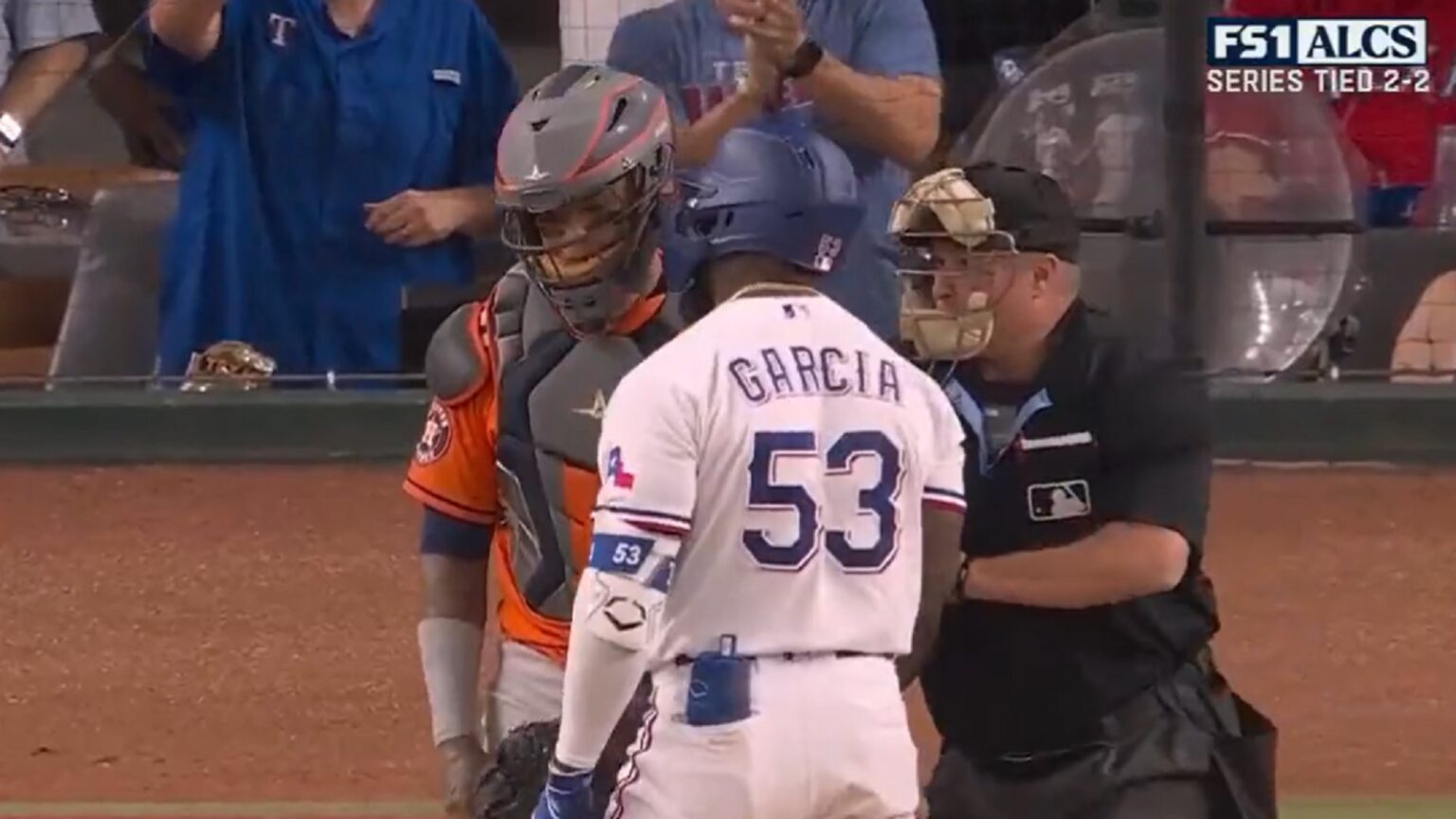 Adolis Garcia gets in Martin Maldonado's face after being hit