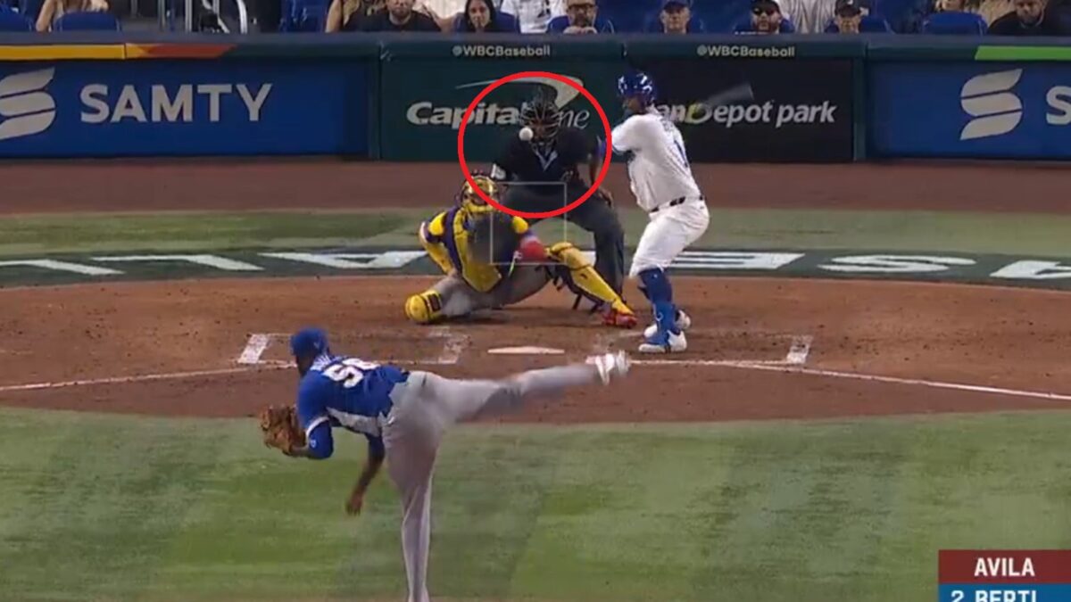 Umpire Jeremie Rehak takes a scary pitch to the mask during WBC semifinal